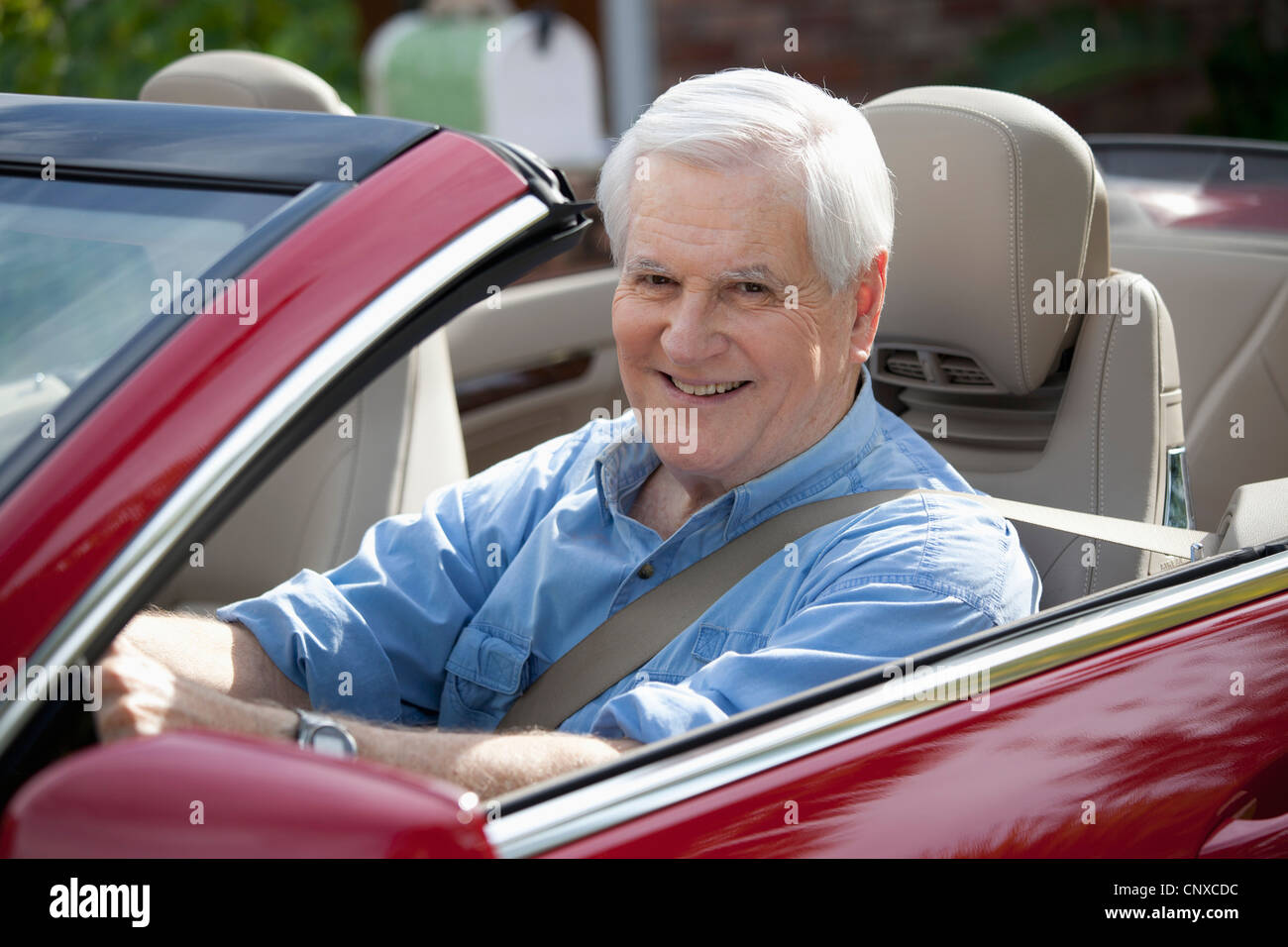 A cheerful senior man driving a convertible sports car Stock Photo - Alamy