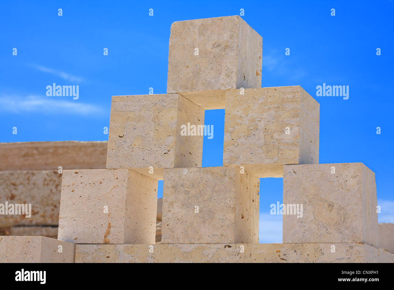blocks of limestone processed and ready for use, are against the blue ...
