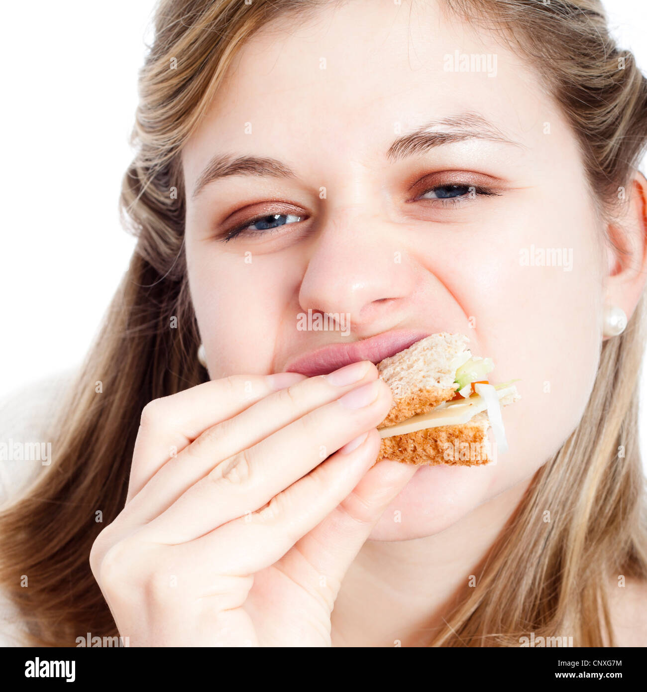 Close up of young woman enjoying eating sandwich Stock Photo - Alamy