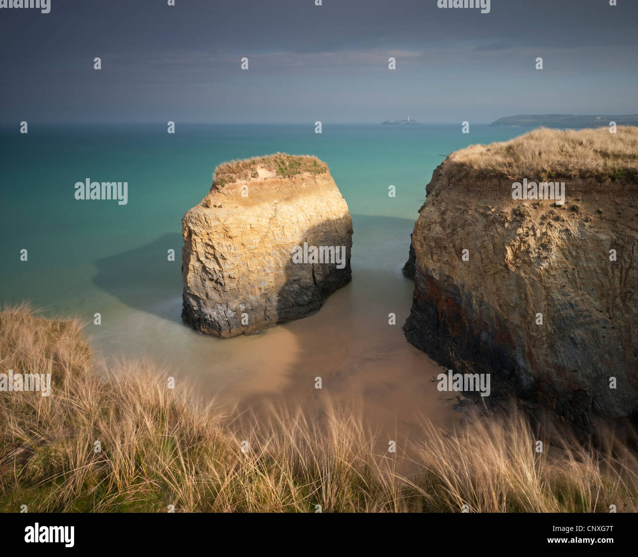 Rock stack on the sandy beach at Gwithian Towans, Cornwall, England ...