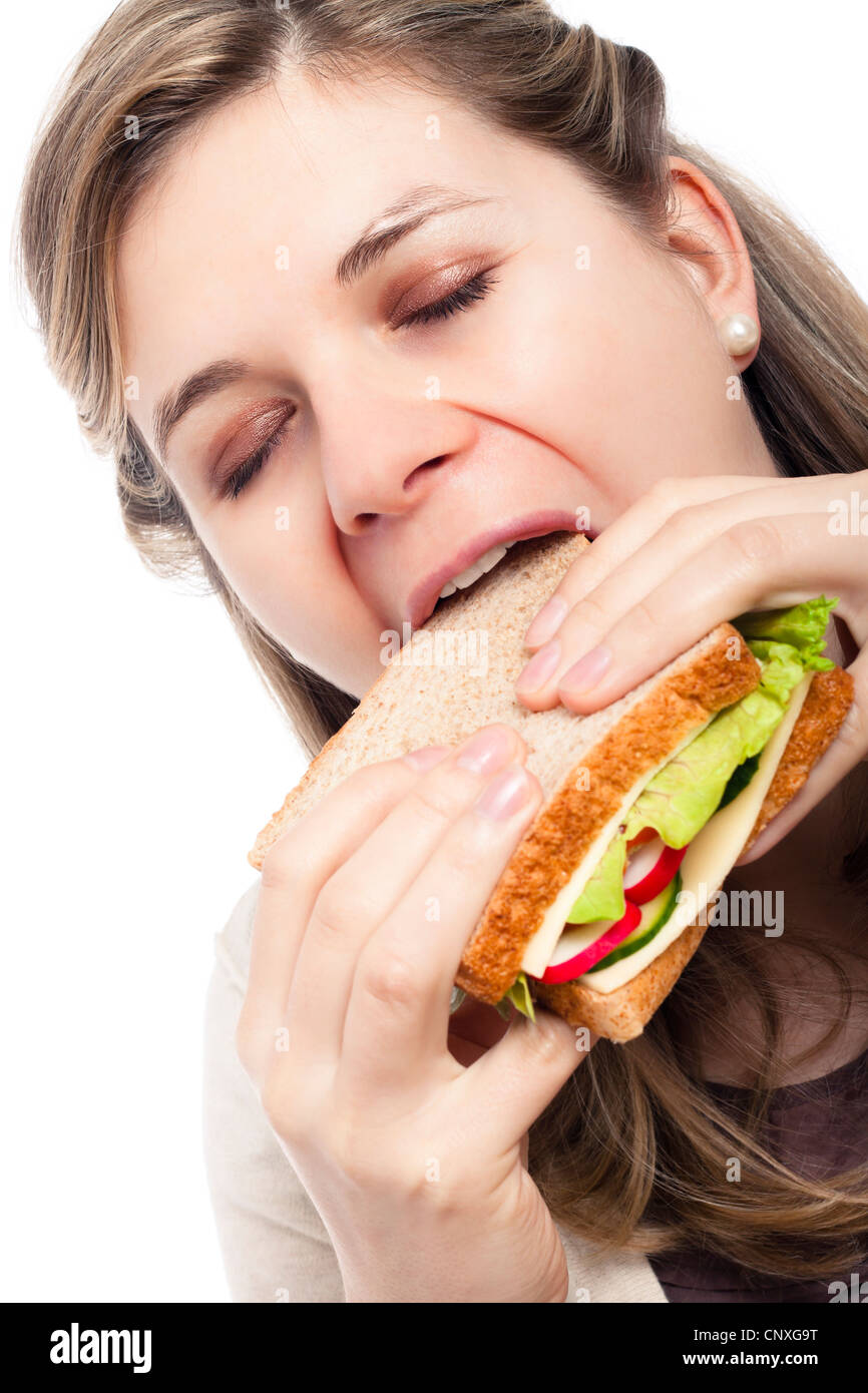 Beautiful young happy woman eating sandwich, isolated on white ...