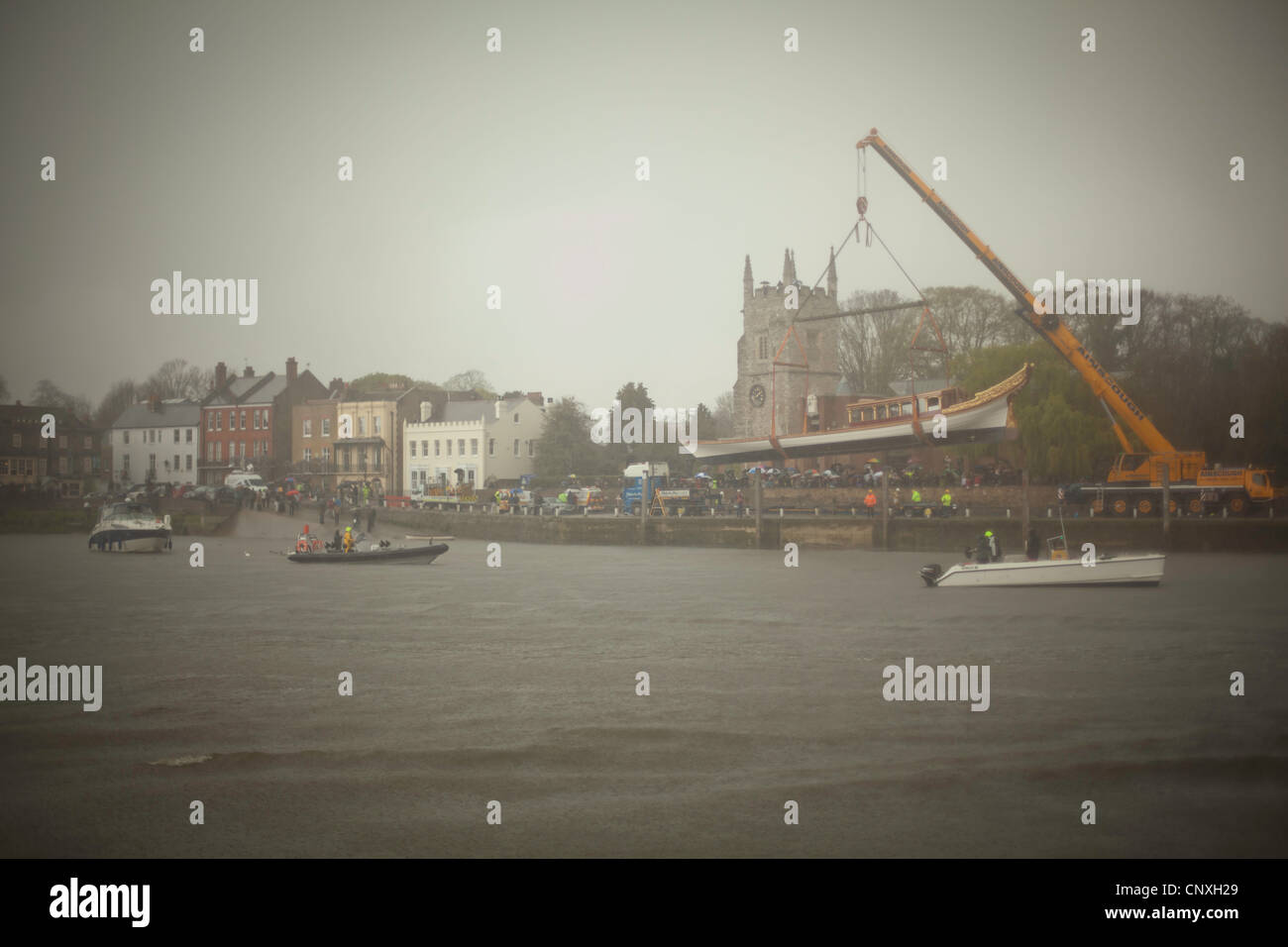 The Royal Barge, Gloriana, being lowered into the Thames at Isleworth ...