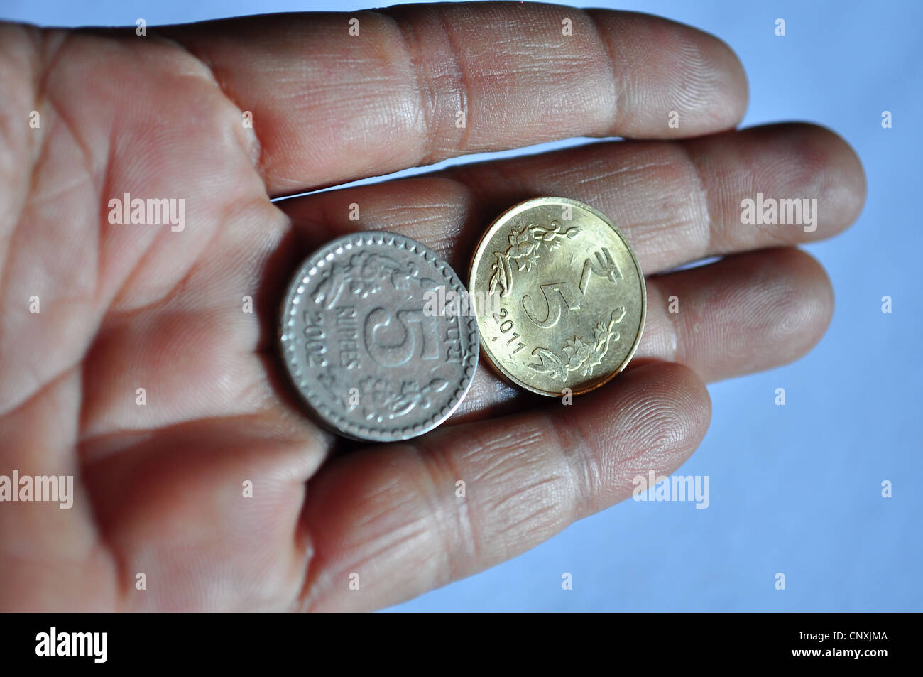 Two 5 rupee indian coin in a human hand Poona ,Maharashtra,India Stock ...