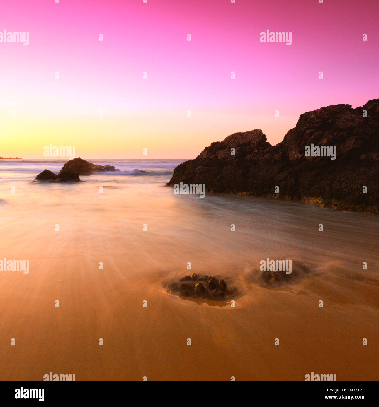 coastal rock at sandy beach in evening light, United Kingdom, Scotland ...