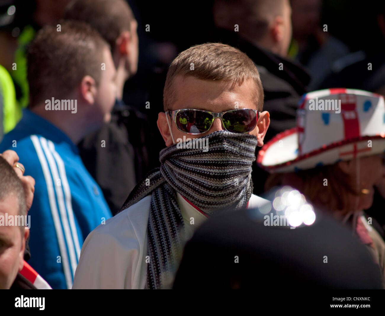 Marching on an EDL rally in Brighton a young man hides his face Stock ...