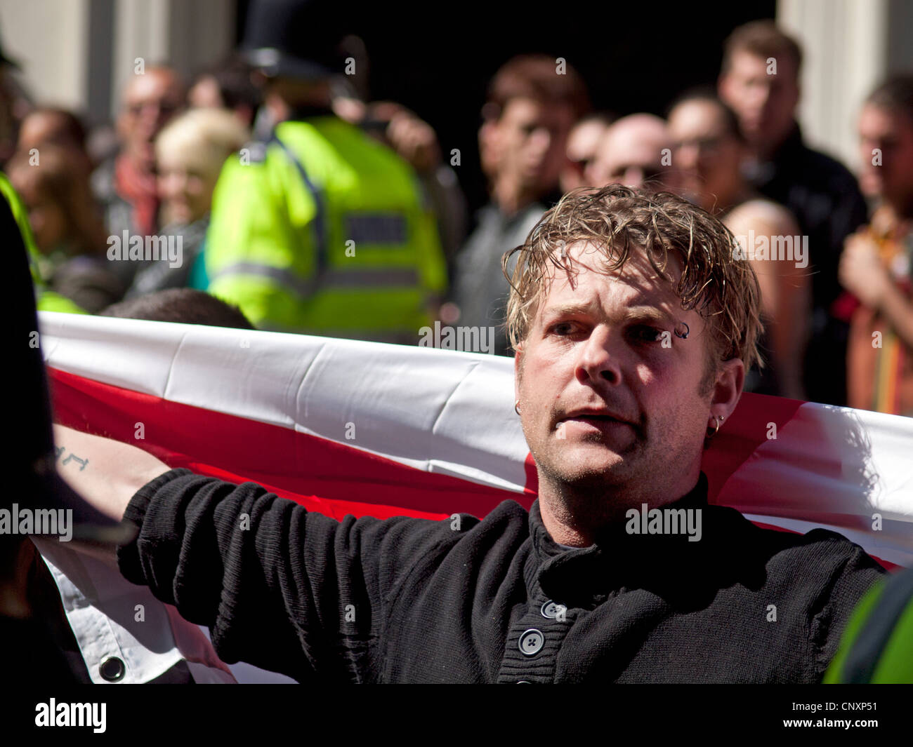 A young man with his flag on an EDL march in Brighton Stock Photo - Alamy