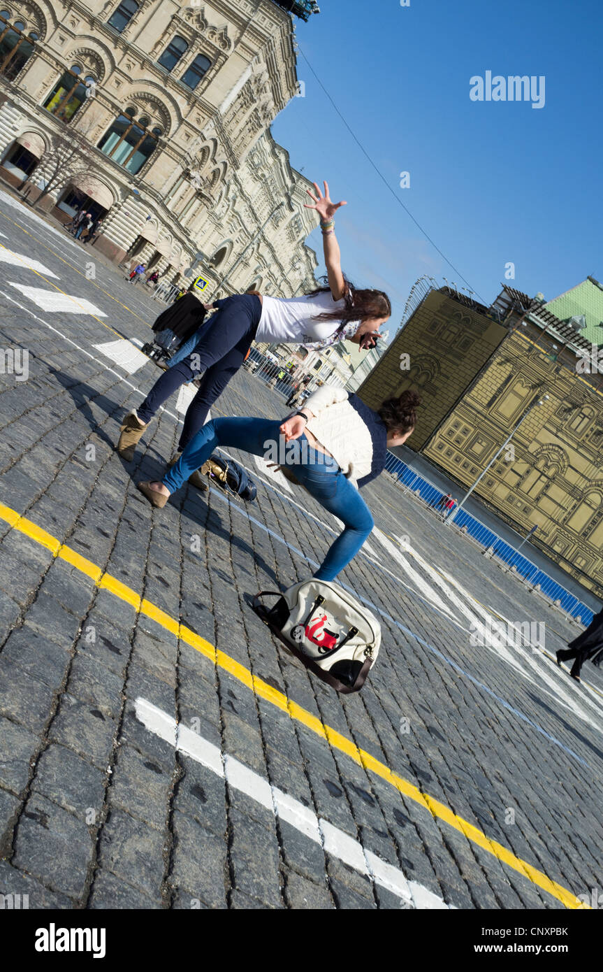 Two young girls posing on the Red Square of Moscow Kremlin Stock Photo ...