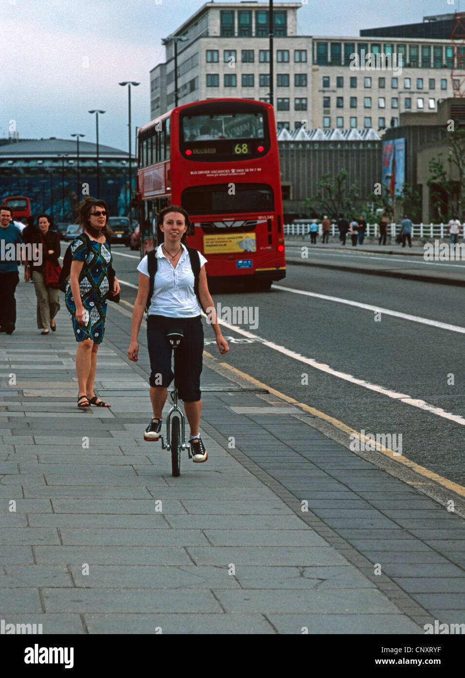 Woman on unicycle on waterloo bridge hi-res stock photography and ...