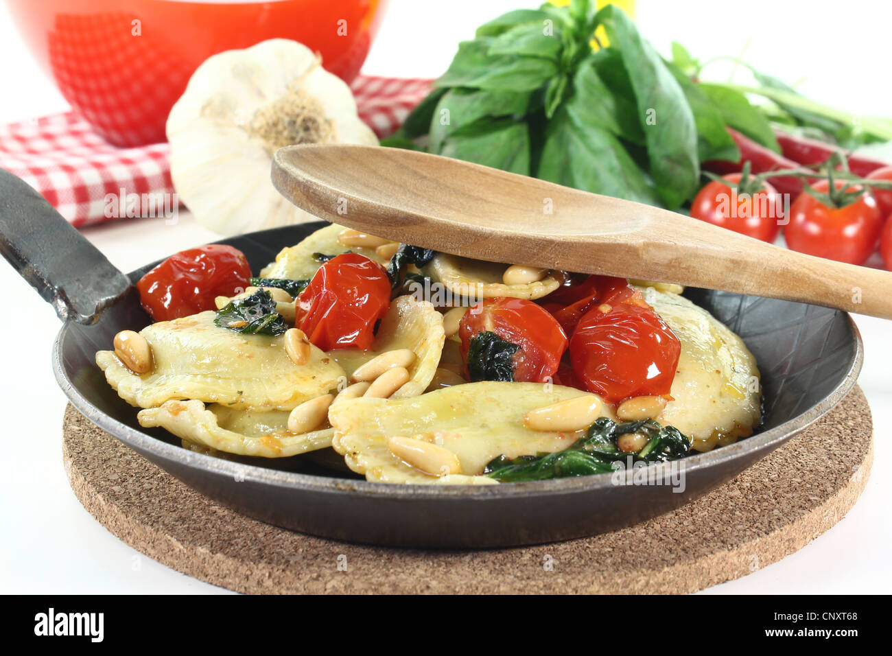 Rocket and Ricotta Cappelletti with pine nuts, tomatoes and basil in a ...