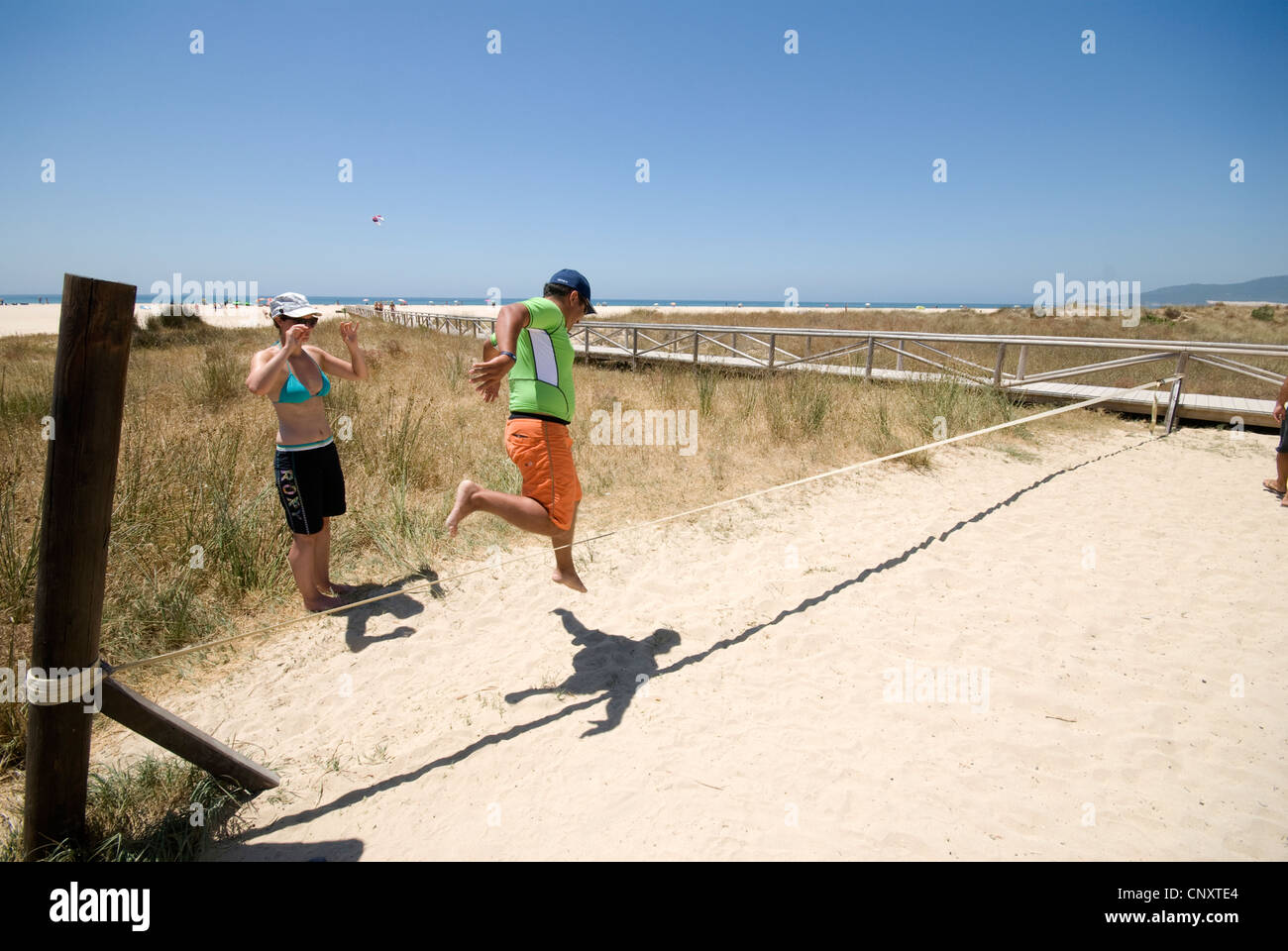 Boy falling off tightrope at beach bar play area Stock Photo - Alamy