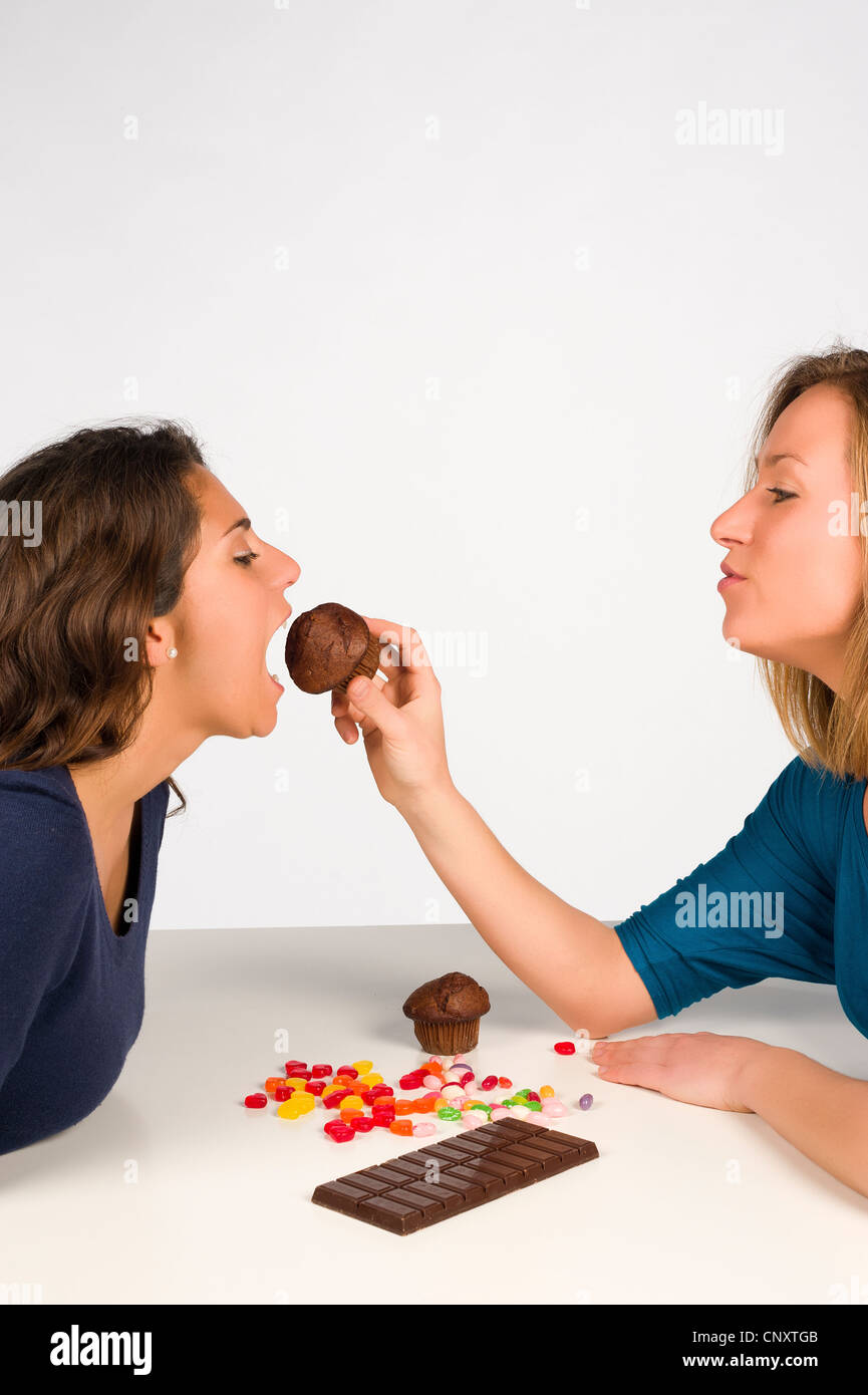 Giving in to a treat, two friends having fun Stock Photo - Alamy