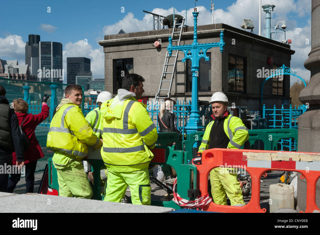 London Tower Bridge British workers workmen in yellow day glow overalls ...