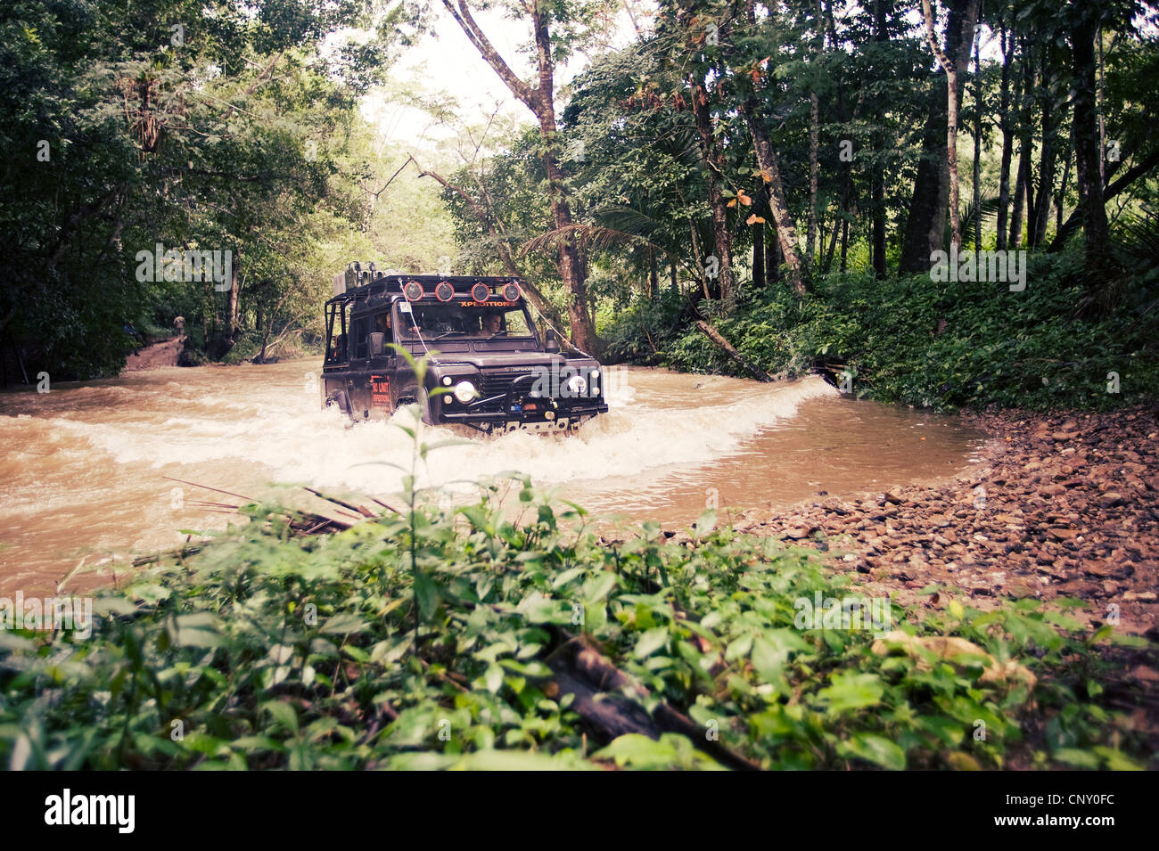 A Land Rover fords a river in Belize Stock Photo - Alamy