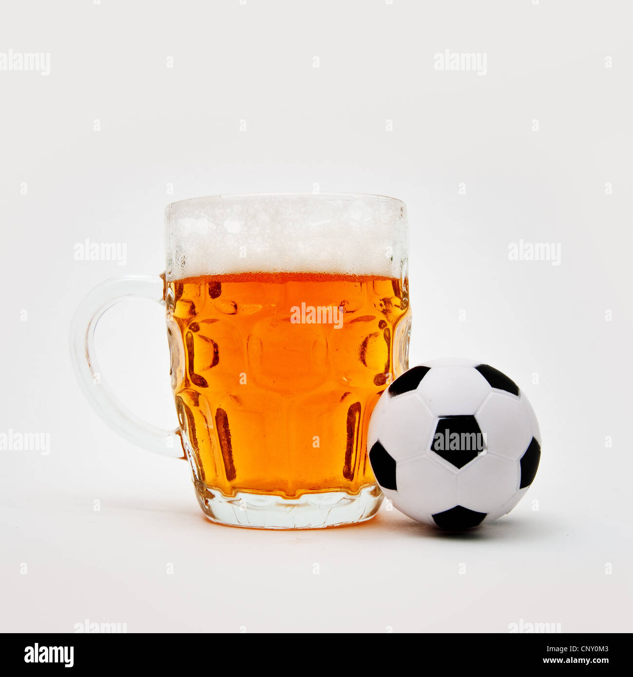 Glass of cold beer and a small soccer ball Stock Photo - Alamy