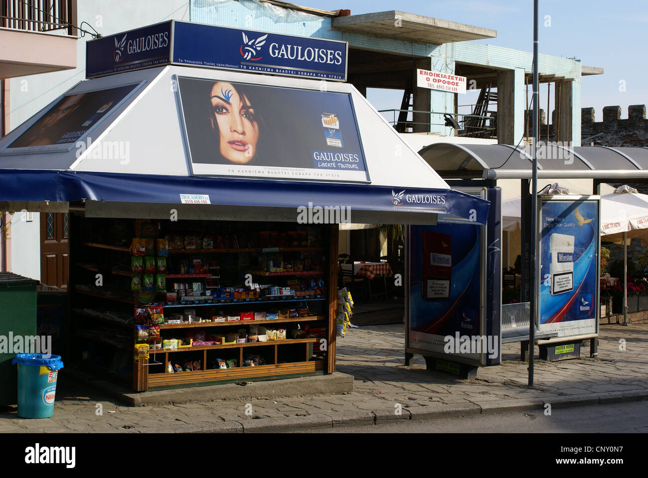 A kiosk and a bus stop with tobacco advertising in Thessaloniki, Greece ...