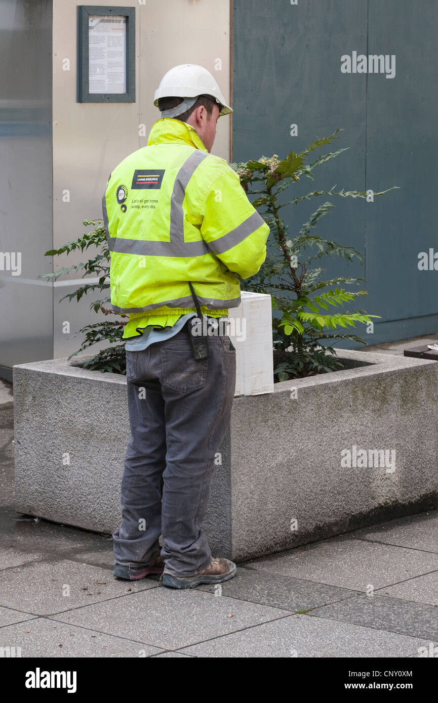 City of London British worker workman in yellow day glow jacket & white ...