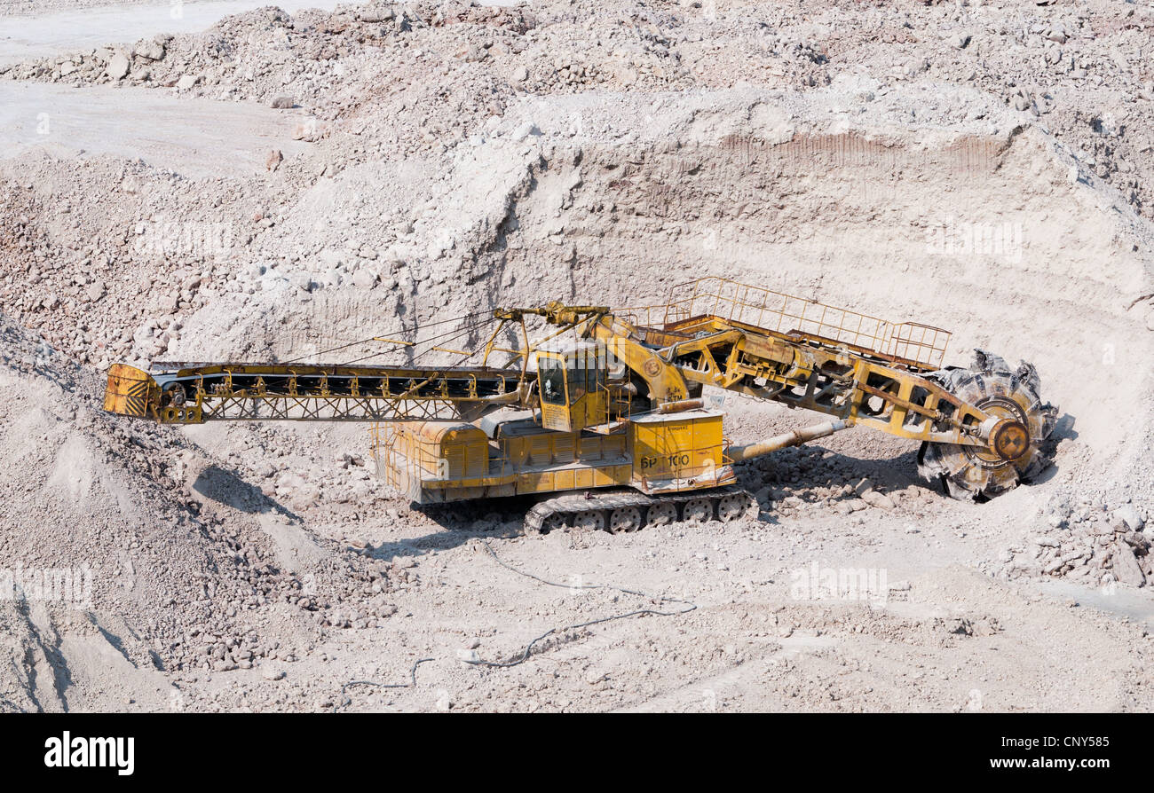A construction vehicle loading clay onto a cargo truck Stock Photo - Alamy