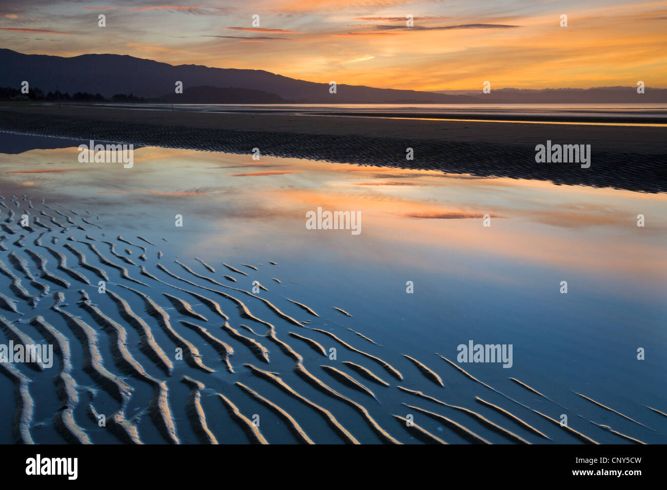 Ripples of sand on Pohara Beach at sunset, Golden Bay, South Island ...