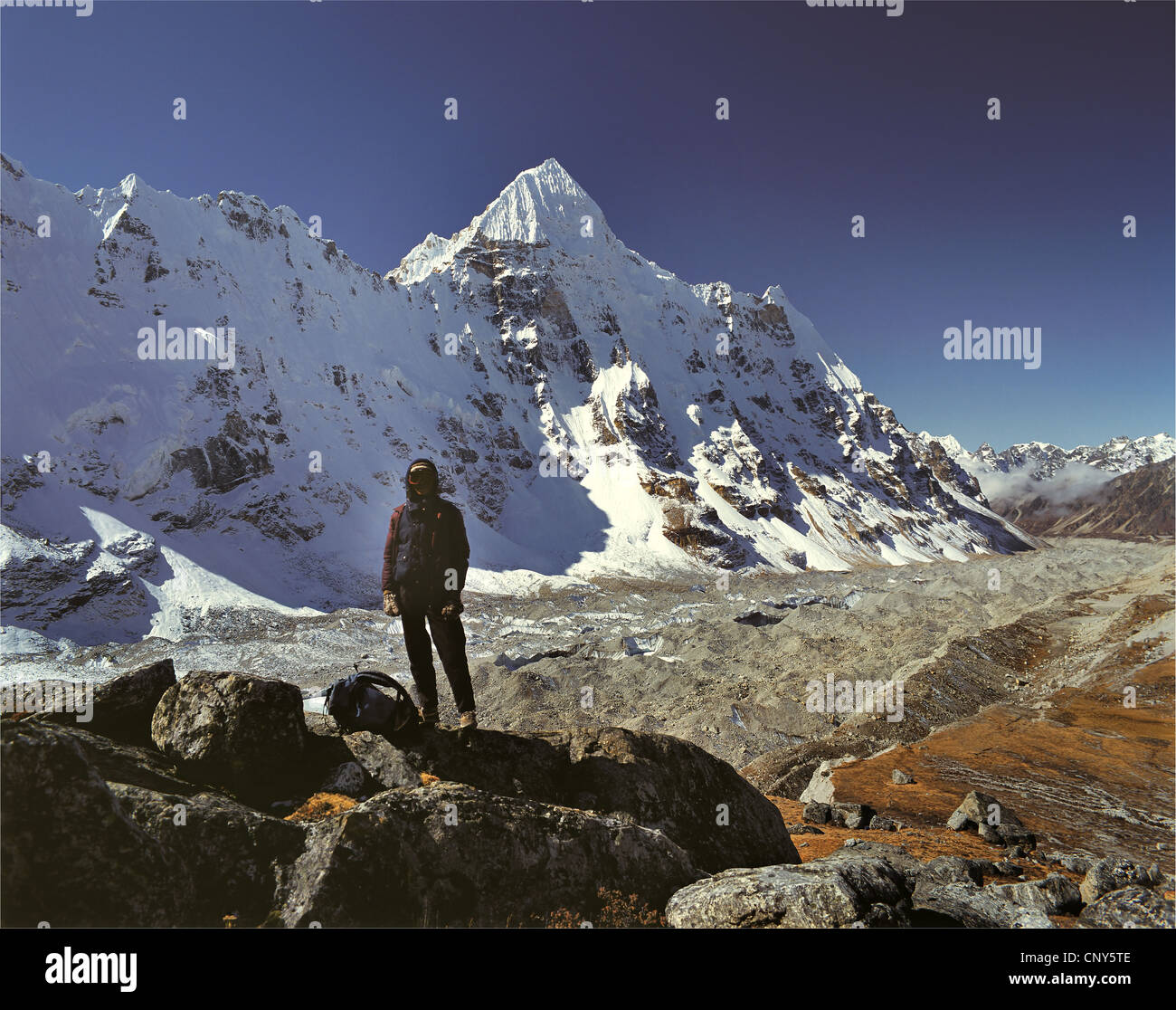 Nepali porter stand in front of wedge peak and the Kangchenjunga Glacier, Nepal, Kangchendzoenga ...