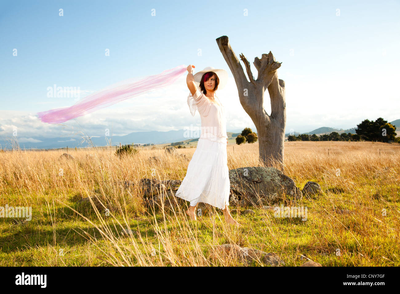 Woman running in a field with Stock Photo - Alamy