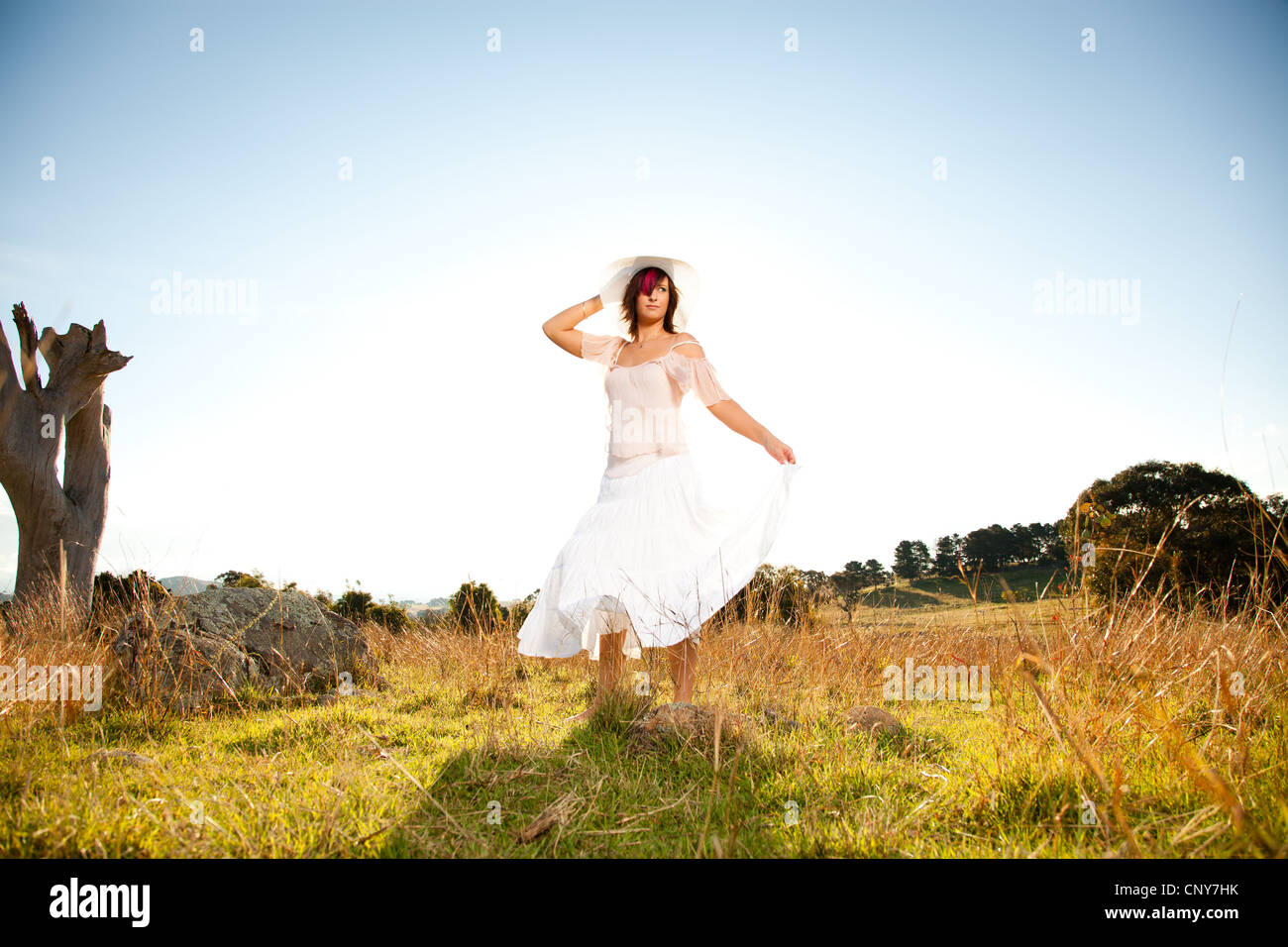 Young woman dancing in a field Stock Photo - Alamy