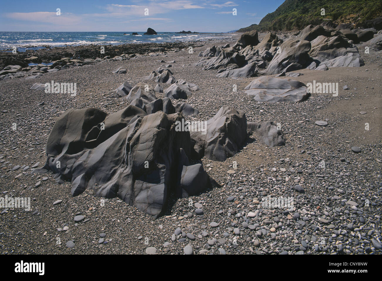 Rock formations on a pebble beach in New Zealand's South Island ...