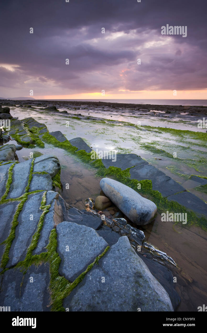 Stormy sunset over the Bristol Channel, viewed from the rocky shores of ...