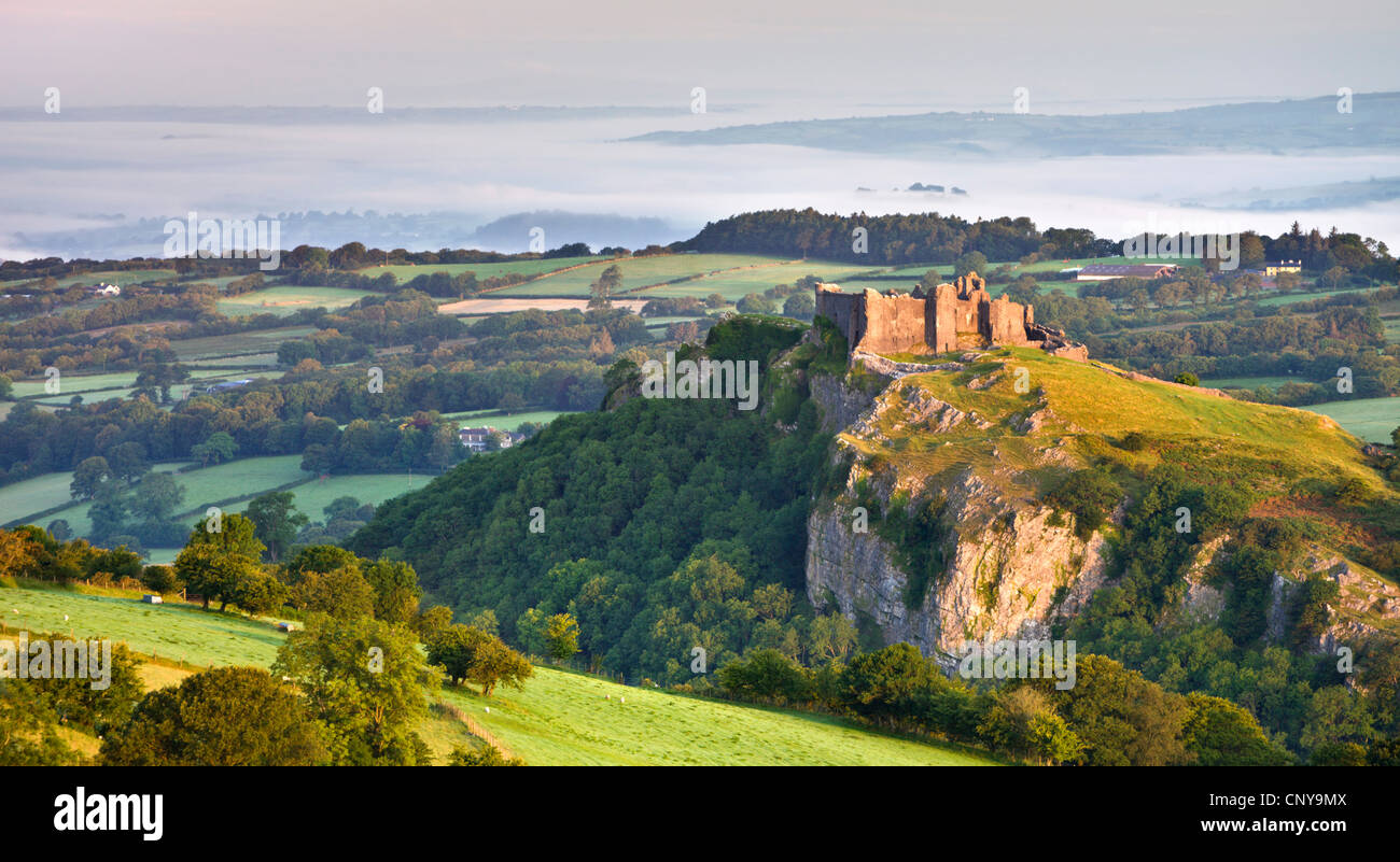 Carreg Cennen Castle at dawn on a misty summer morning, Brecon Beacons ...