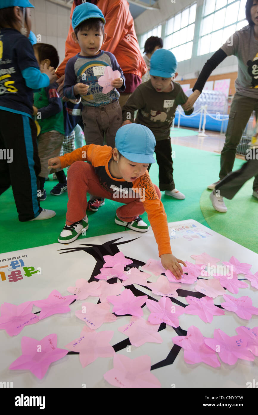 Young nursery school children play in the Red Cross 'Smile Park', in ...