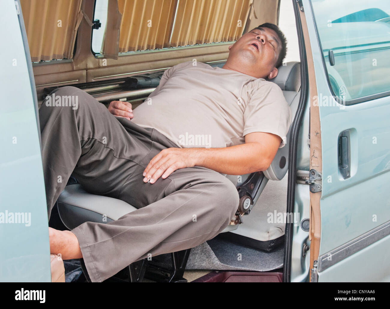 Portrait of tired driver taking 40 winks during a break Stock Photo - Alamy