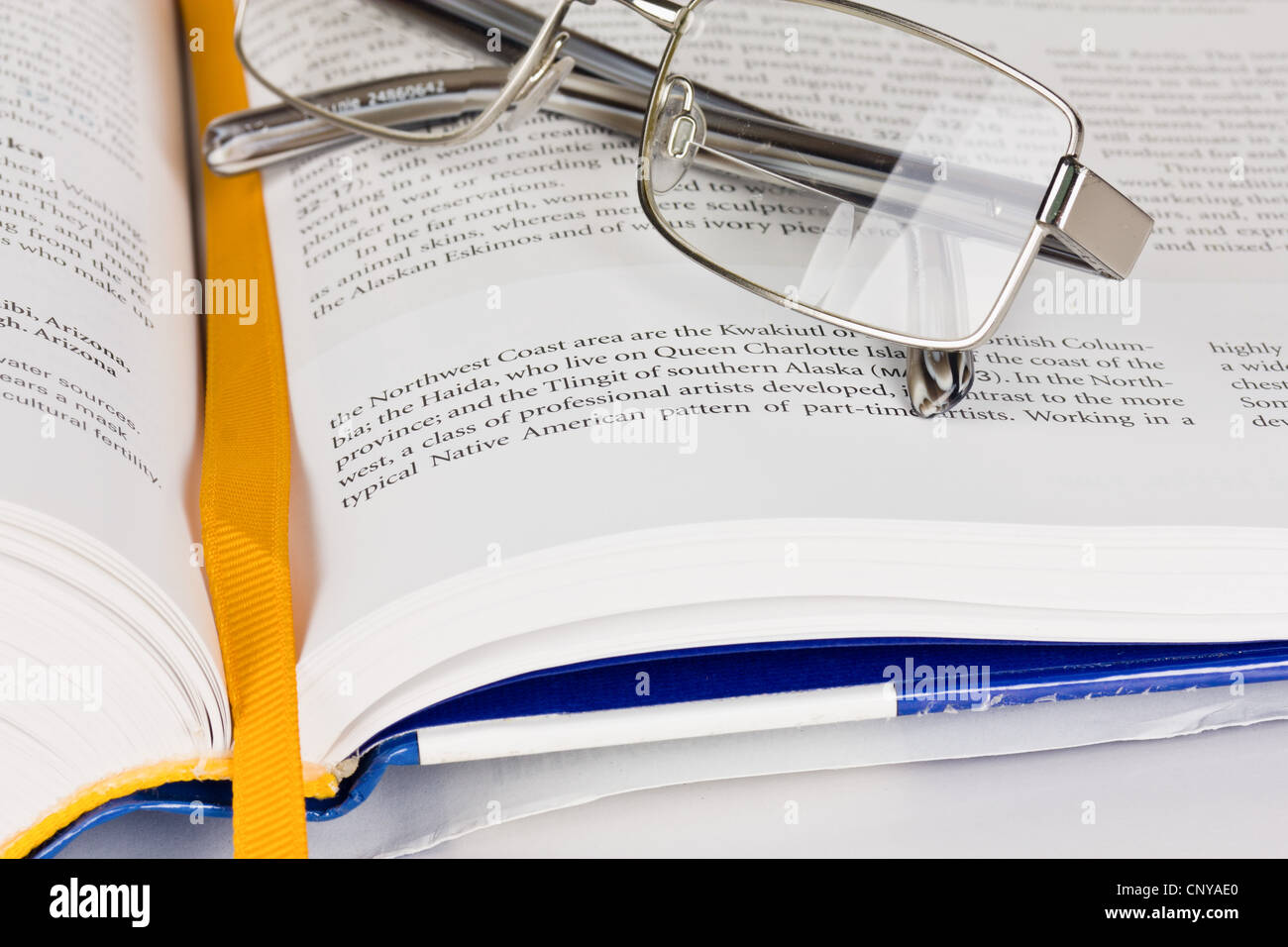 Spectacles eyeglasses on book with bookmark Stock Photo - Alamy