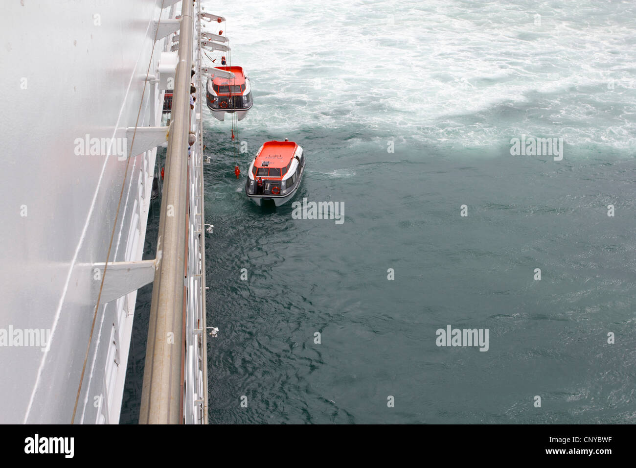 Lifeboat tenders being reloaded onto cruise ship Stock Photo - Alamy