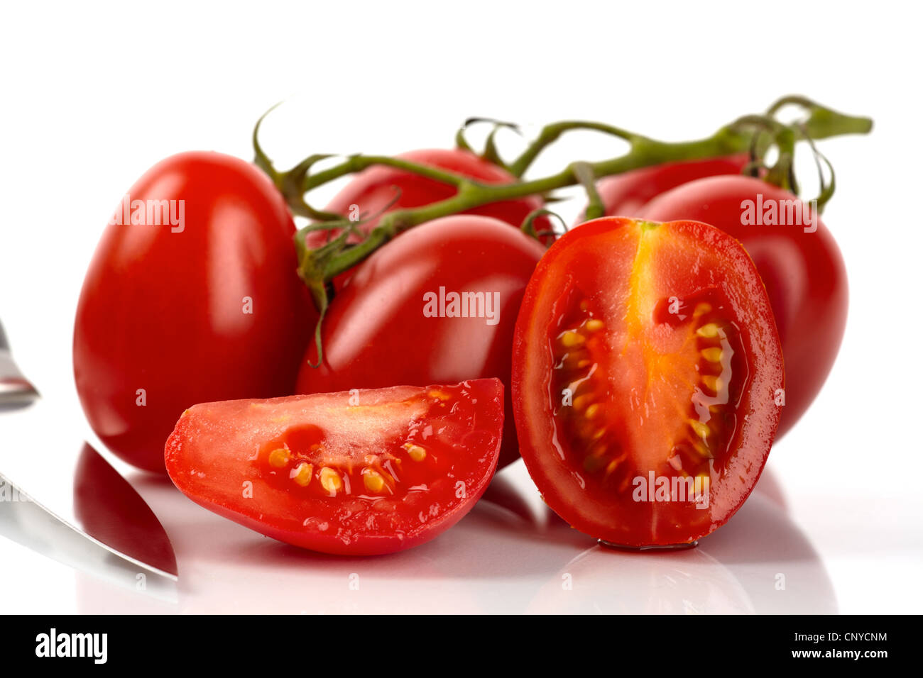 Fresh roma tomatoes cut in front of white background Stock Photo - Alamy
