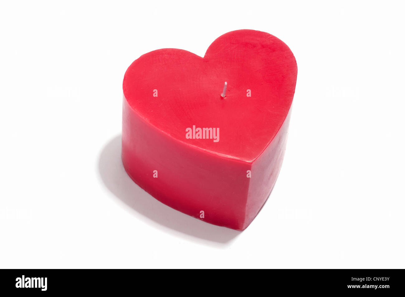A red heart shaped candle Stock Photo - Alamy