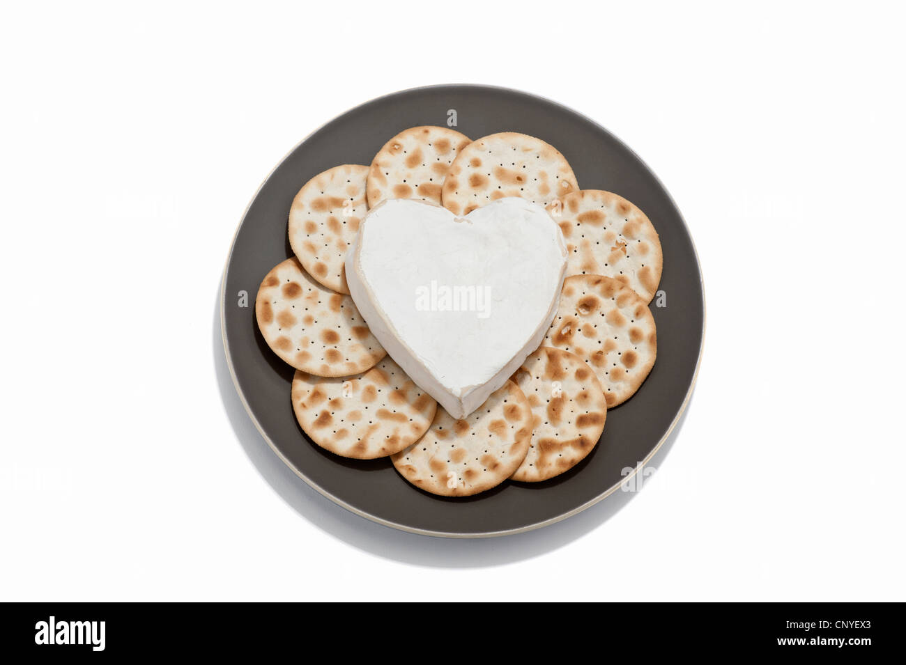 A heart shaped cheese with crackers on a plate Stock Photo - Alamy