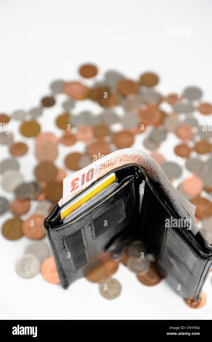 a wallet with a british 10 pound note and coins in the background ...