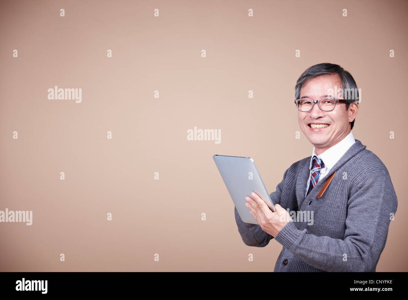 A smiling old man with tablet PC Stock Photo - Alamy