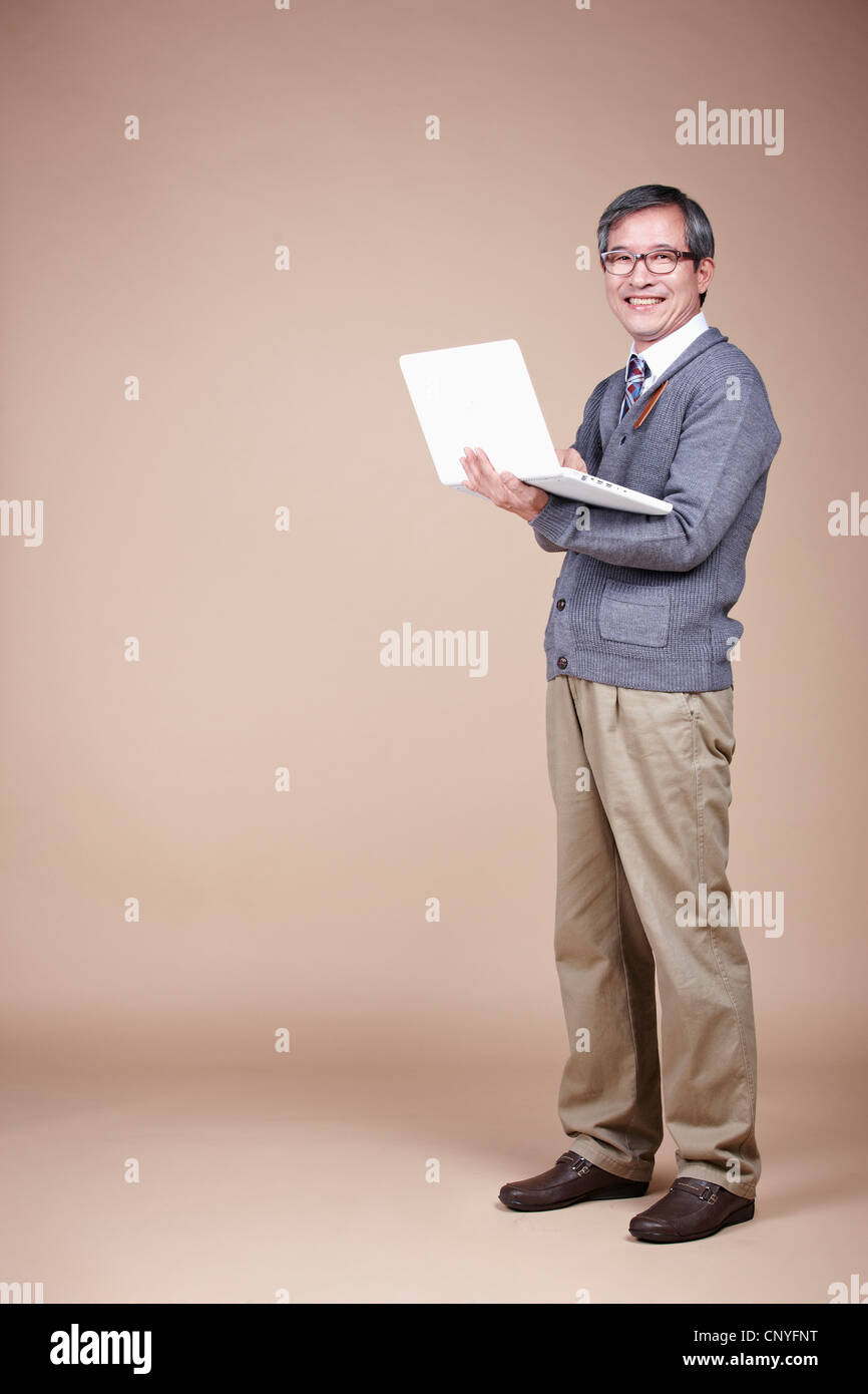 A smiling old man with laptop Stock Photo - Alamy