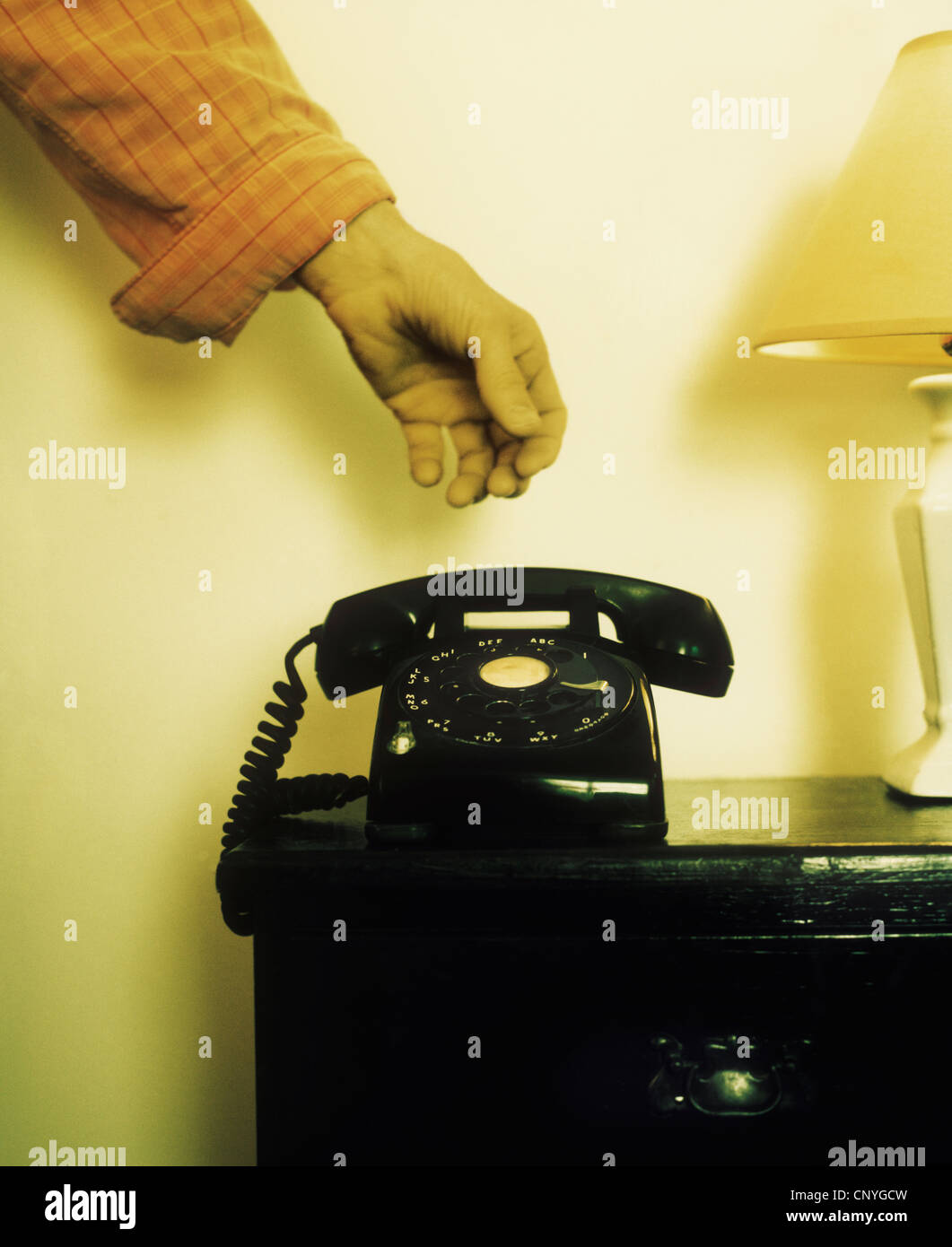 Hand Reaching for Rotary Telephone Stock Photo - Alamy
