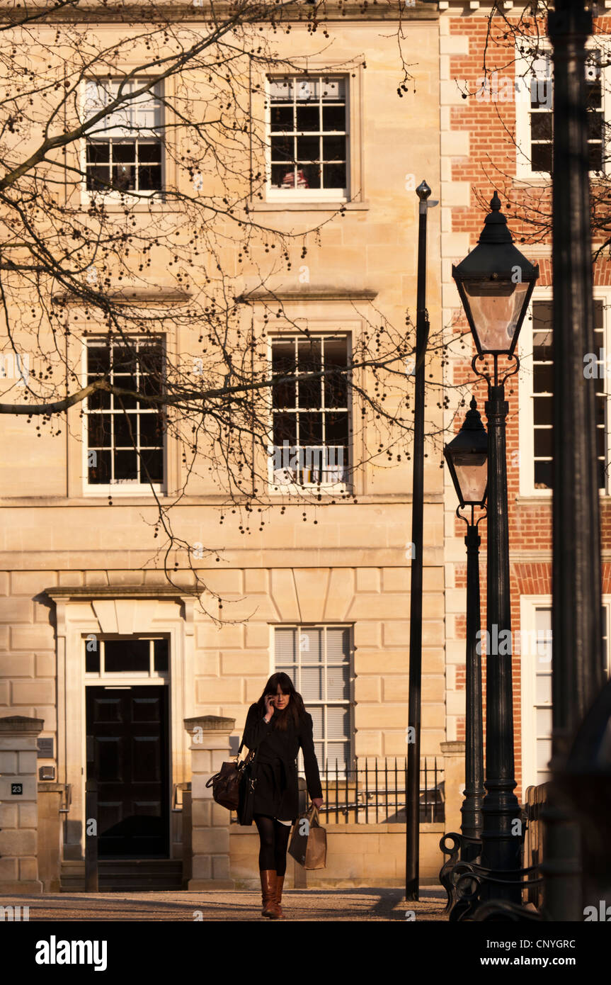 a young woman walking and talking on her mobile phone, Queen Square in ...