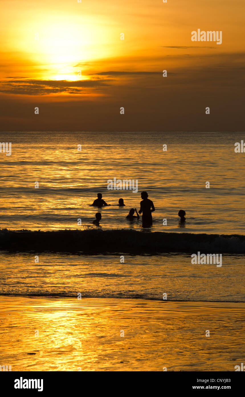 People in the sea at sunset, Kamala Beach, Phuket, Thailand Stock Photo ...