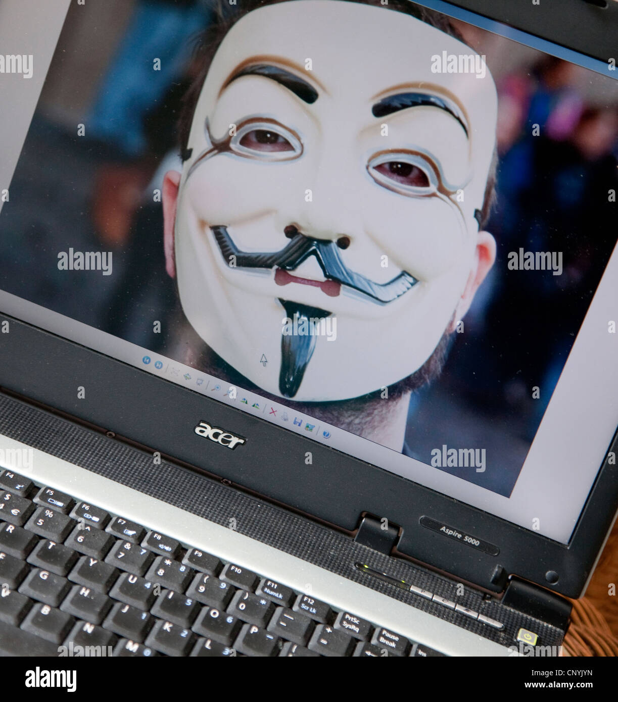 "Anonymous" masked face on computer screen, London Stock Photo - Alamy