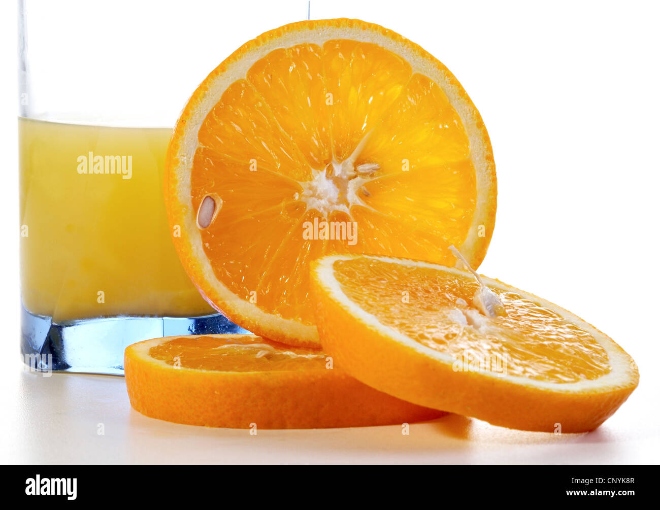 Segments of an orange and a glass of juice on a white background Stock ...