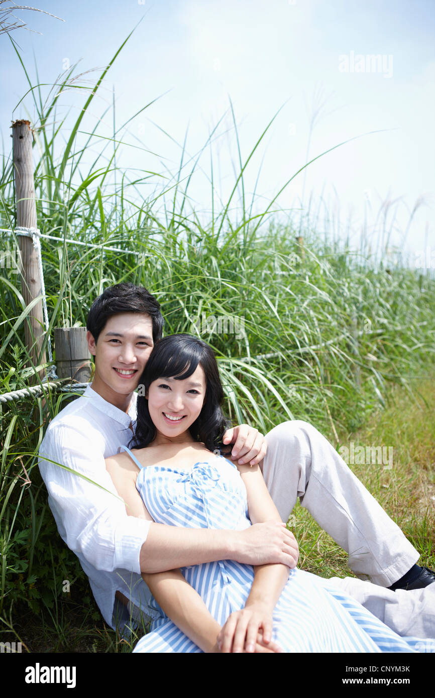 A couple sitting in the reed filed Stock Photo - Alamy
