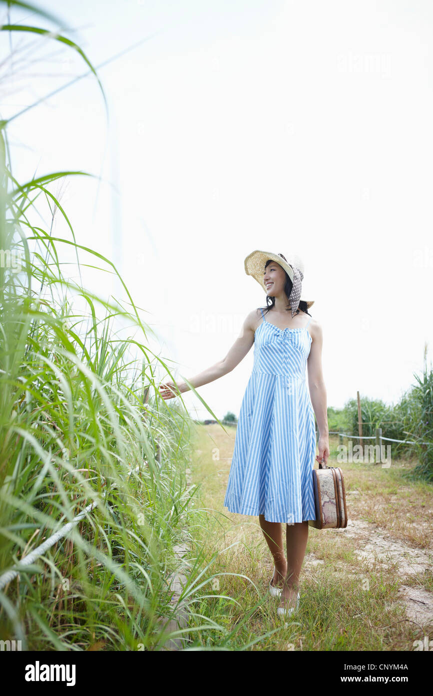A woman traveling in the reed field Stock Photo - Alamy