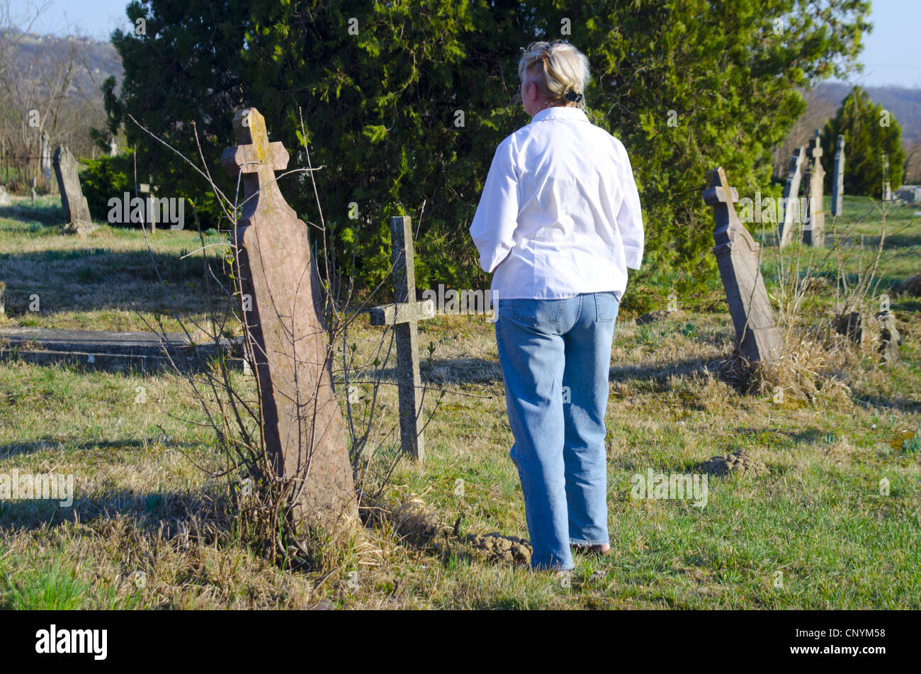 woman walks through an old cemetery Stock Photo - Alamy