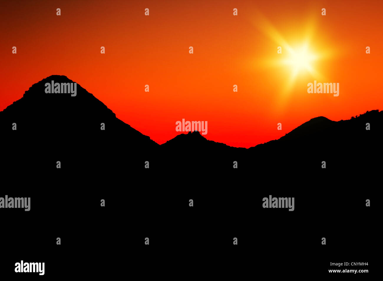 Warm mountains sunset with orange sky & silhouette of mountains Stock ...