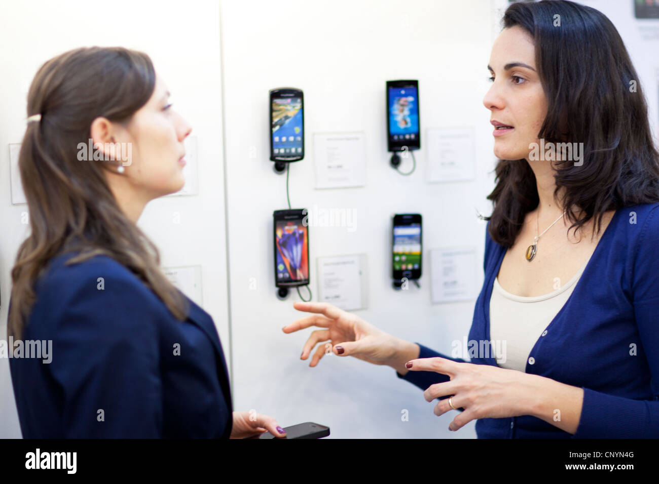 Woman choosing a cell phone Stock Photo - Alamy
