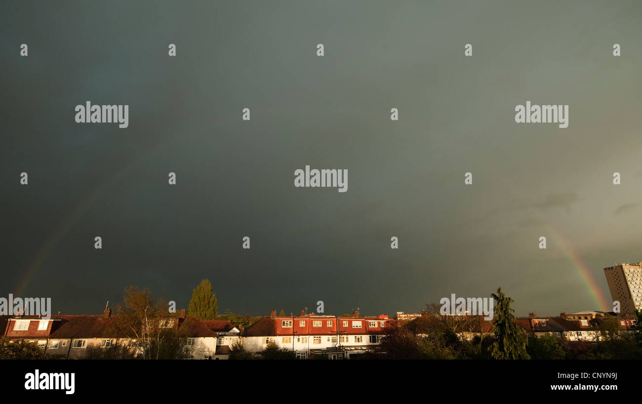 Rainbow over suburban houses Stock Photo - Alamy