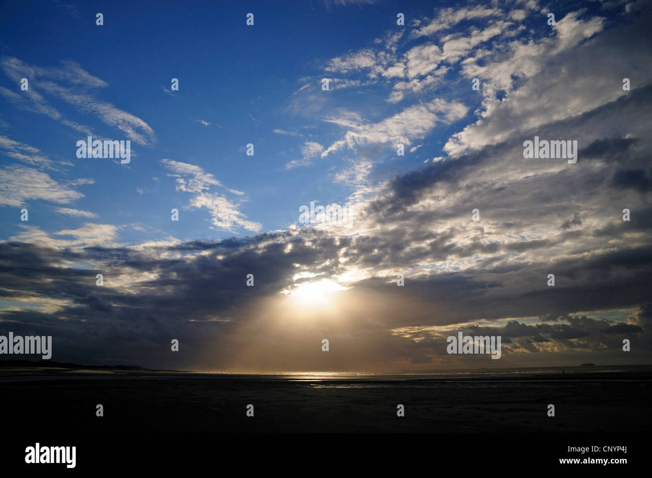 sunbeams breaking through clouds above North Sea, Netherlands, Cadzand ...